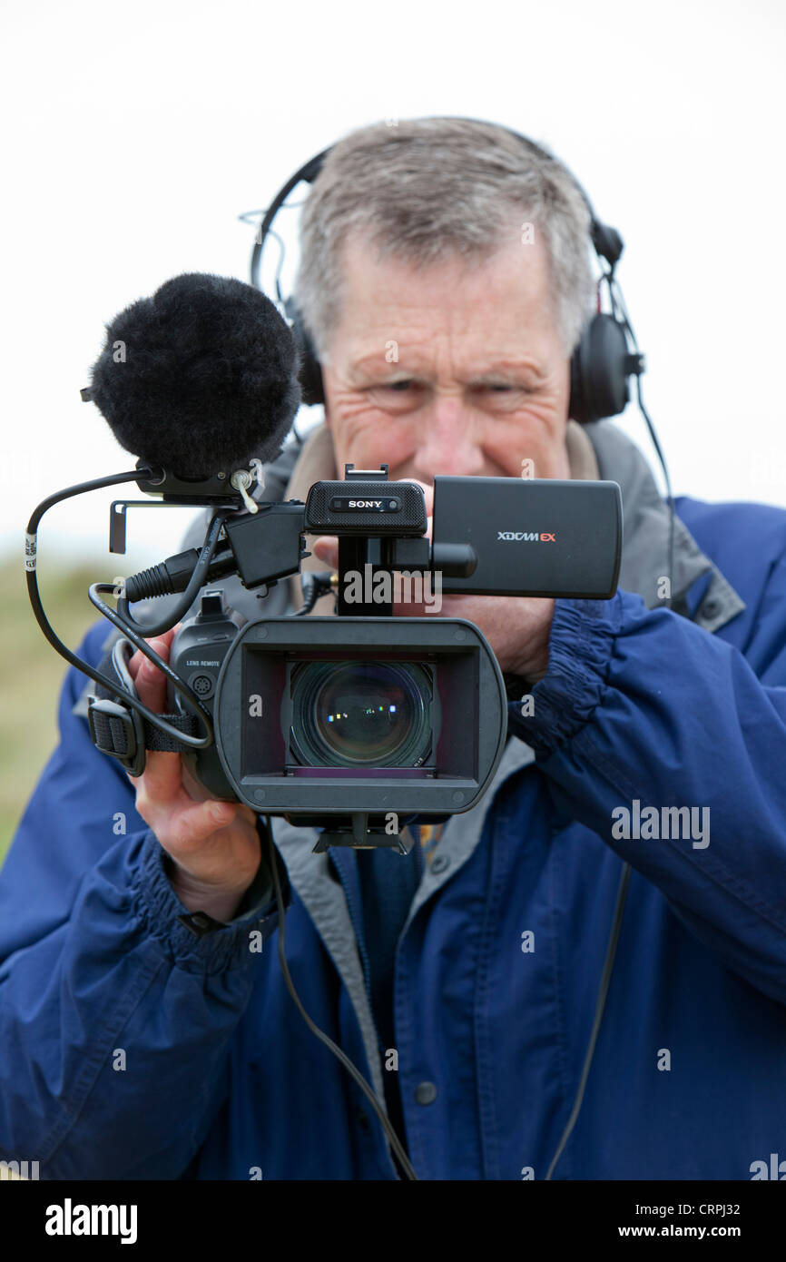 Malcolm Robertson from Anglia News filming a story at Winterton Stock Photo - Alamy