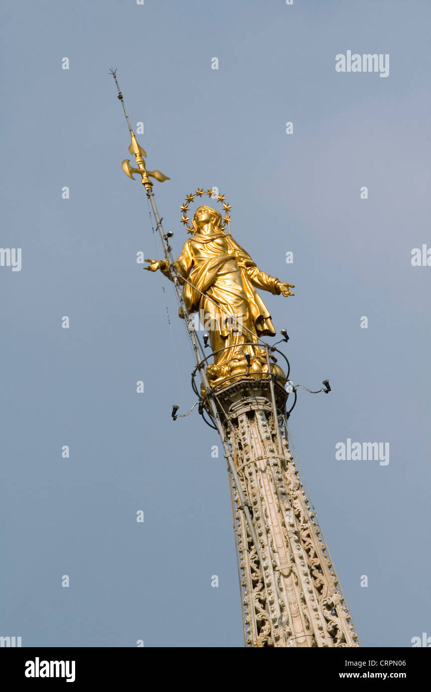 Gold statue crowning a Duomo (Milan Cathedral) spire, Milan, Lombardia ...