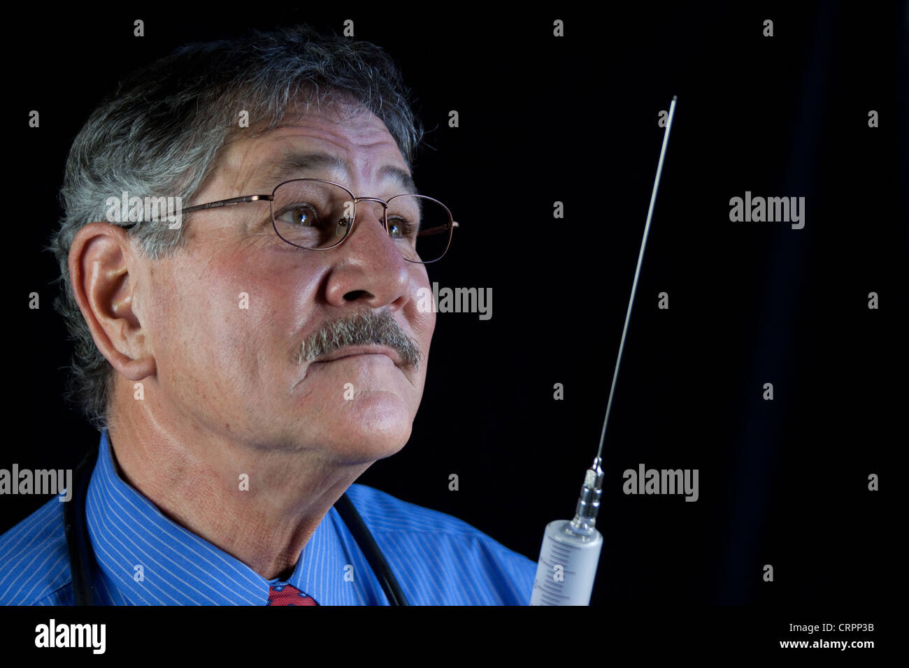 crazy doctor with huge needle and syringe Stock Photo - Alamy