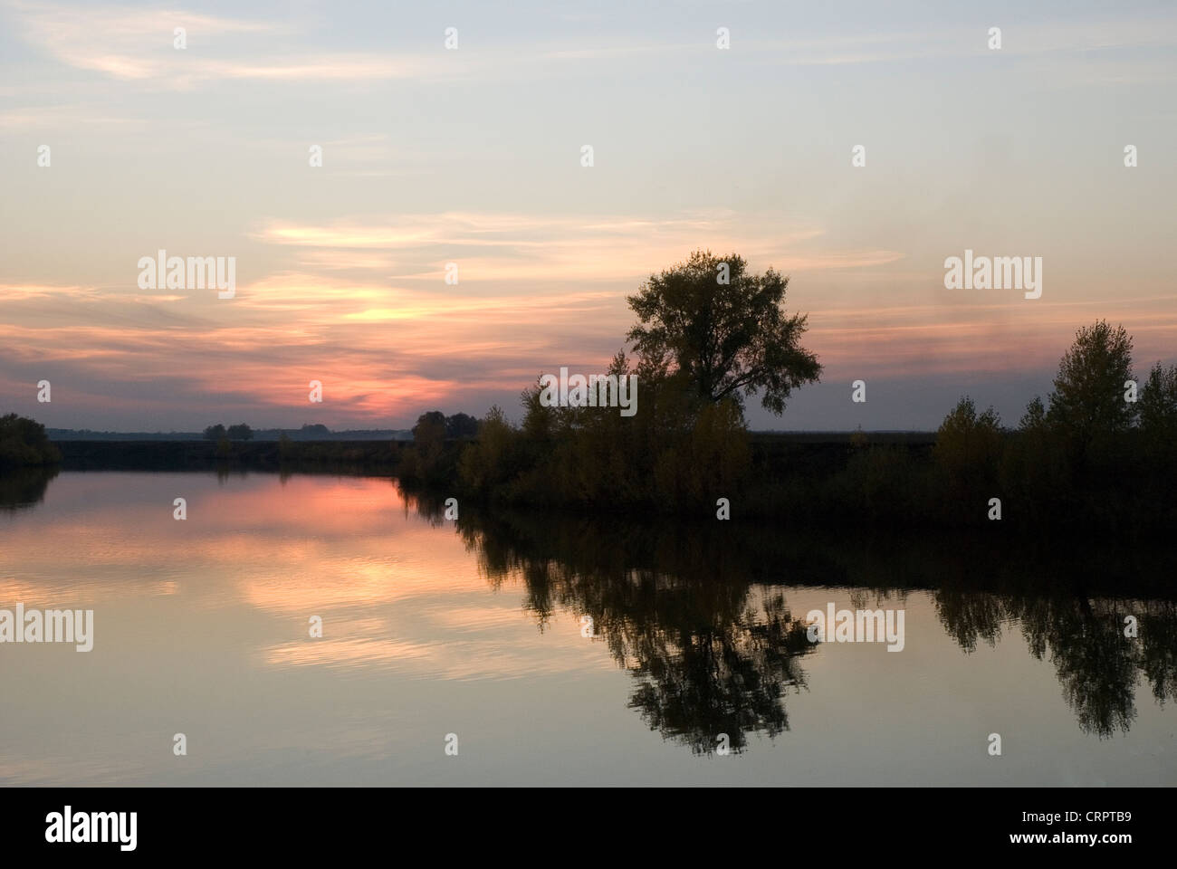 A beautiful sunset or sunrise over a river Stock Photo - Alamy