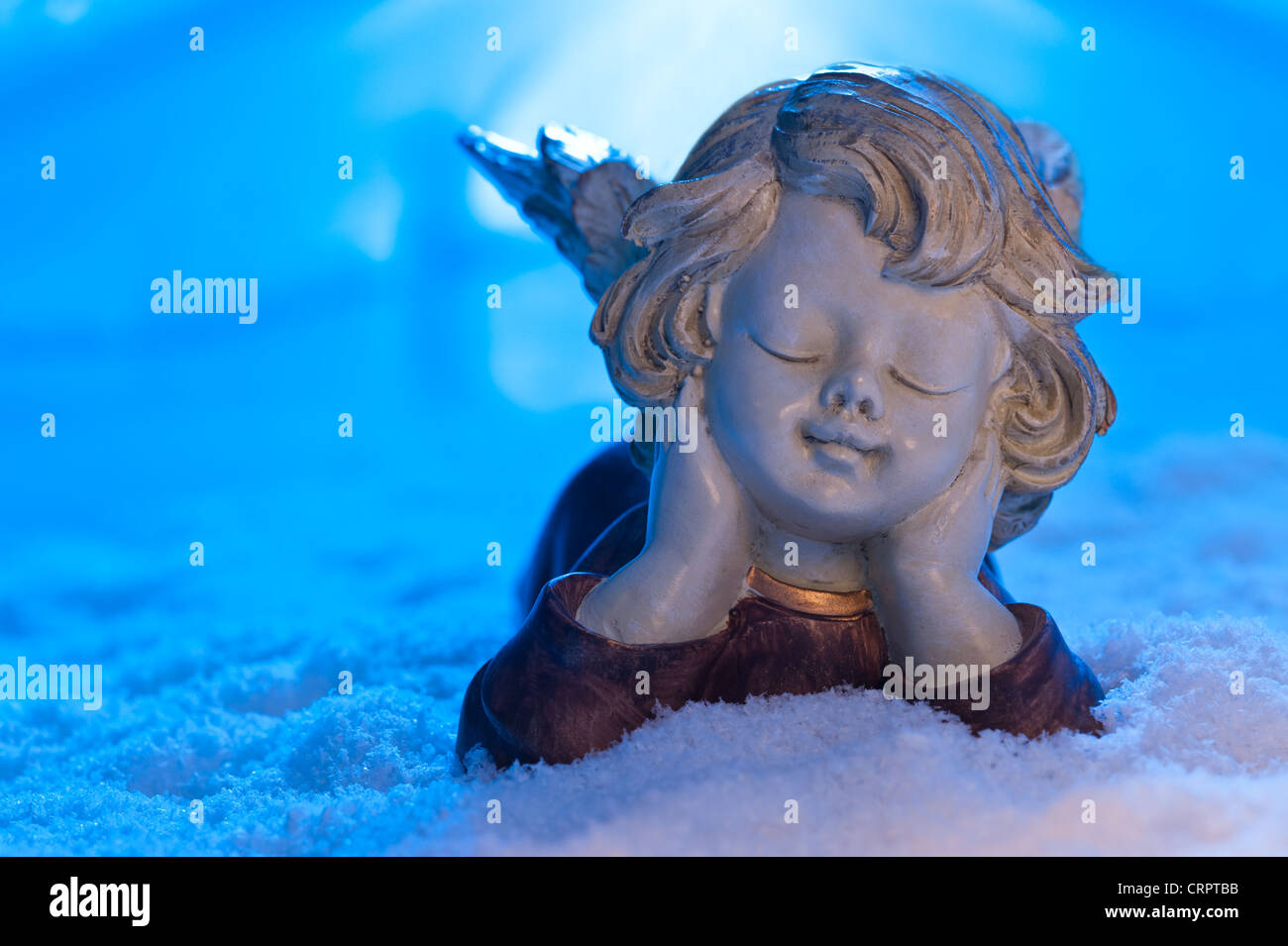 Angel in a beautiful blue snow setting Stock Photo - Alamy