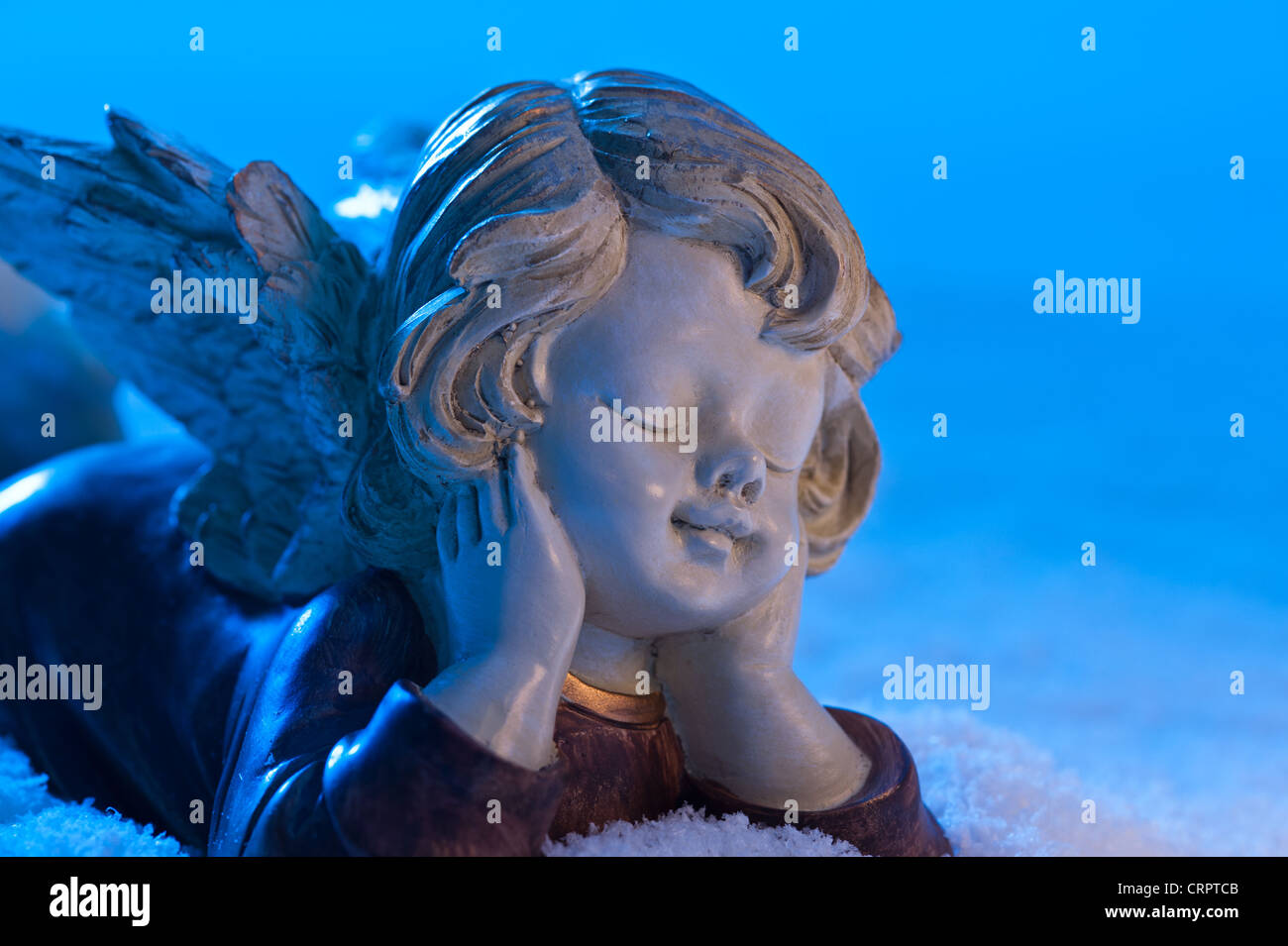 Angel in a beautiful blue snow setting Stock Photo - Alamy
