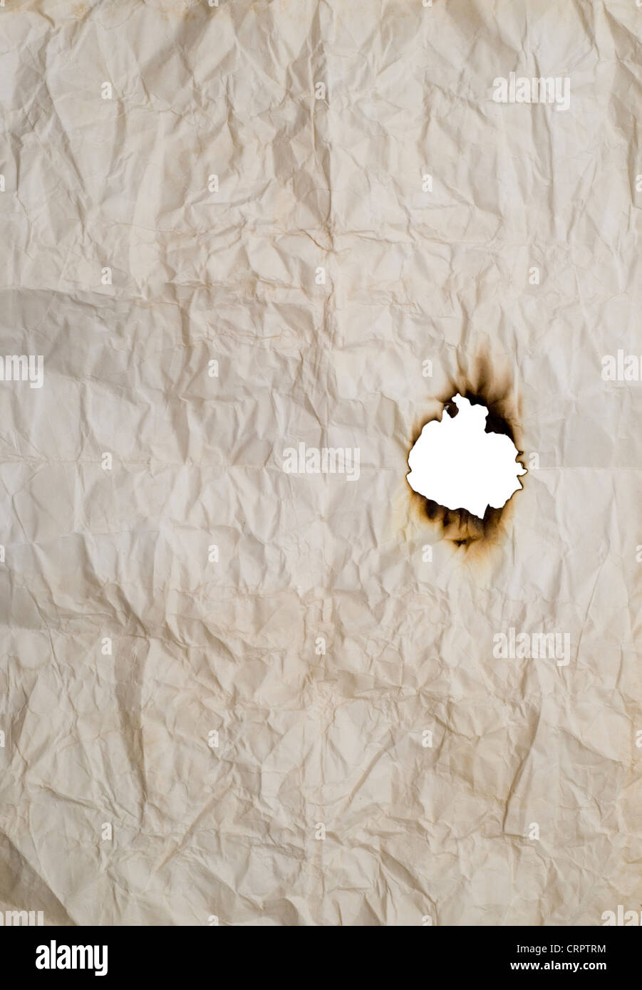 wrinkled paper with burnt hole Stock Photo - Alamy