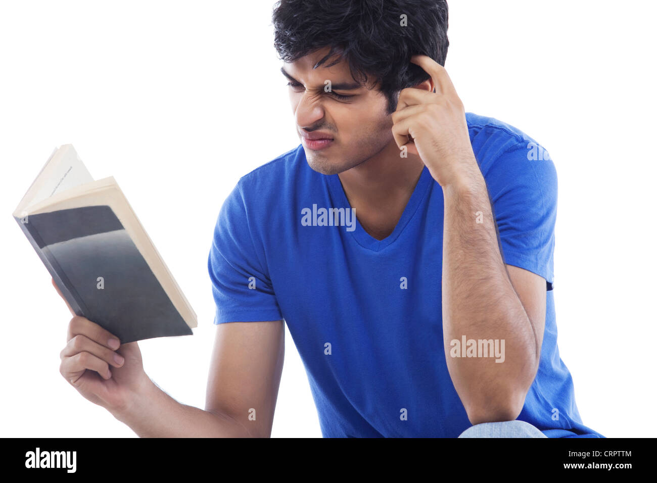 Confused young man book scratching head hi-res stock photography and ...