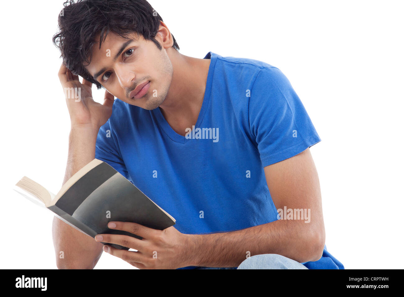 Portrait of young man holding book over white background Stock Photo ...