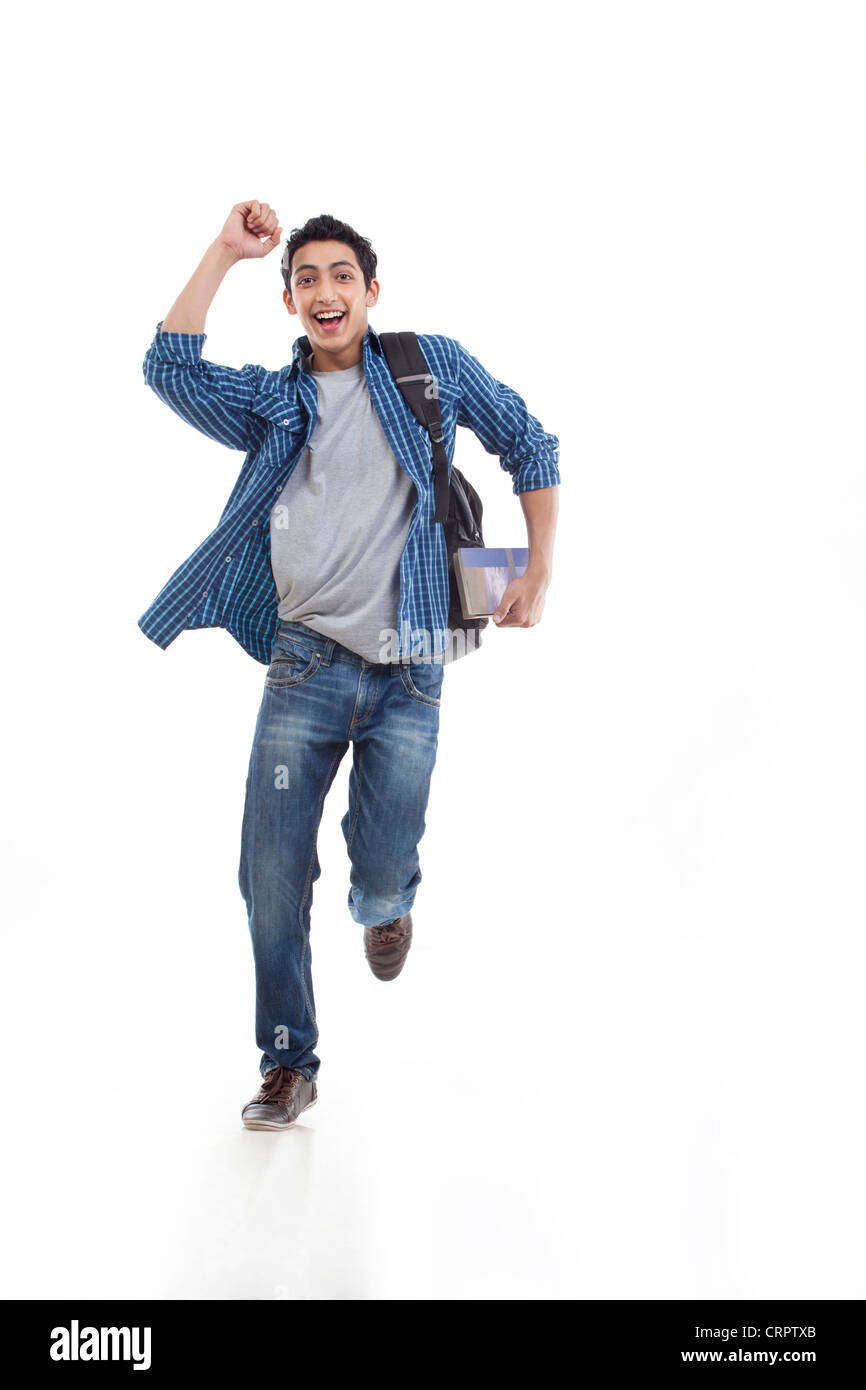 Excited young man running over white background Stock Photo - Alamy