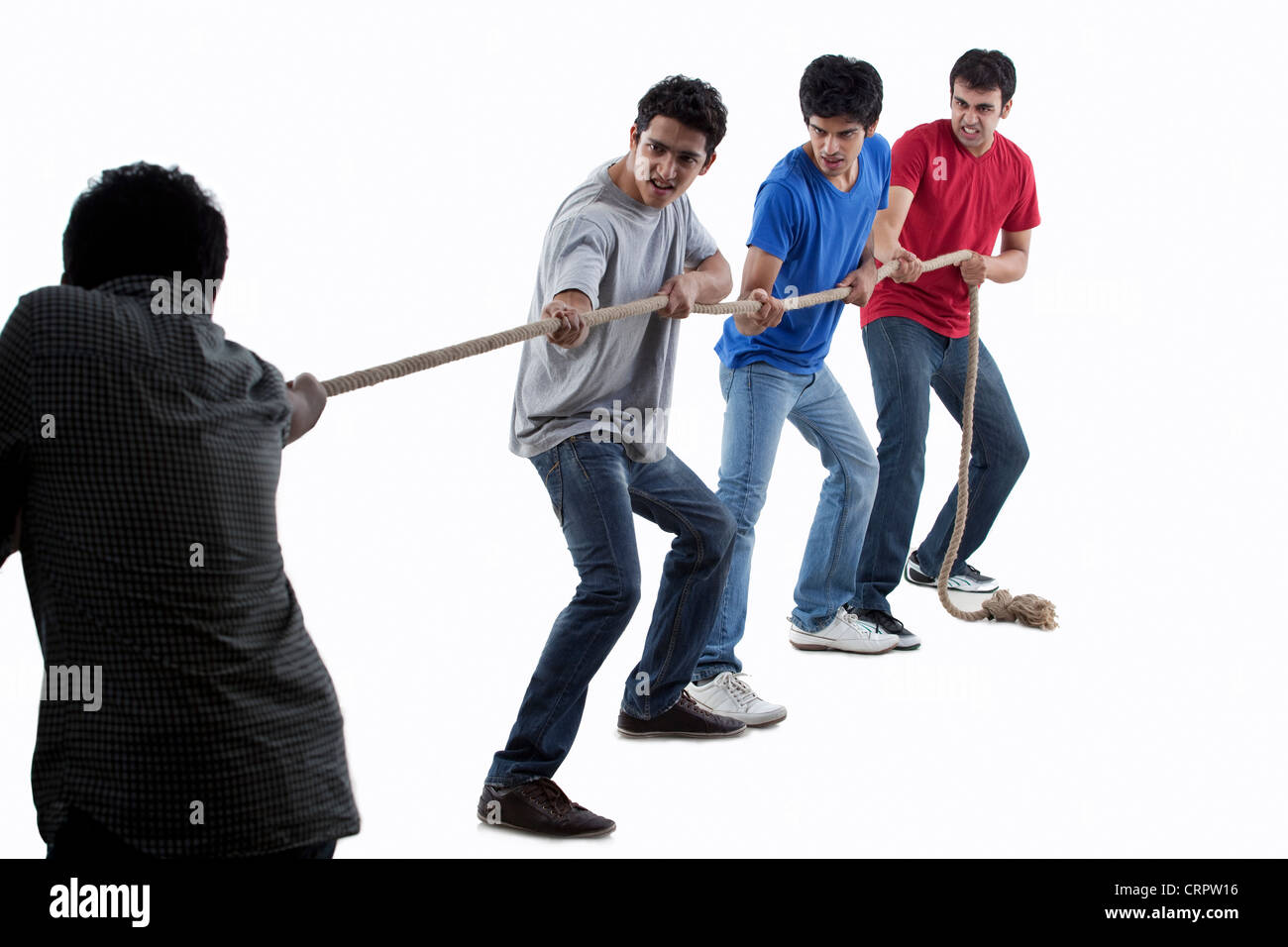 Friends competing in game of tug of war together over white background ...