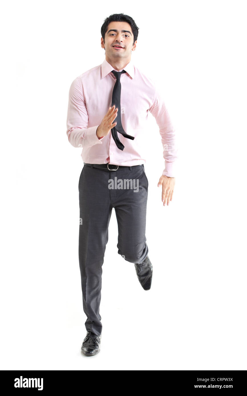 Happy young businessman running over white background Stock Photo - Alamy