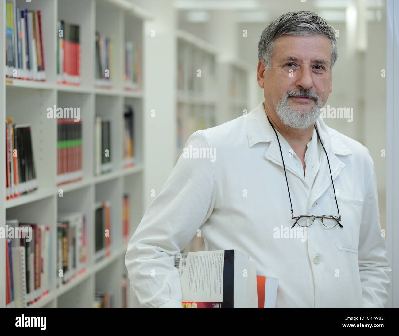 Renowned scientist/doctor in a library of research center/hospital ...