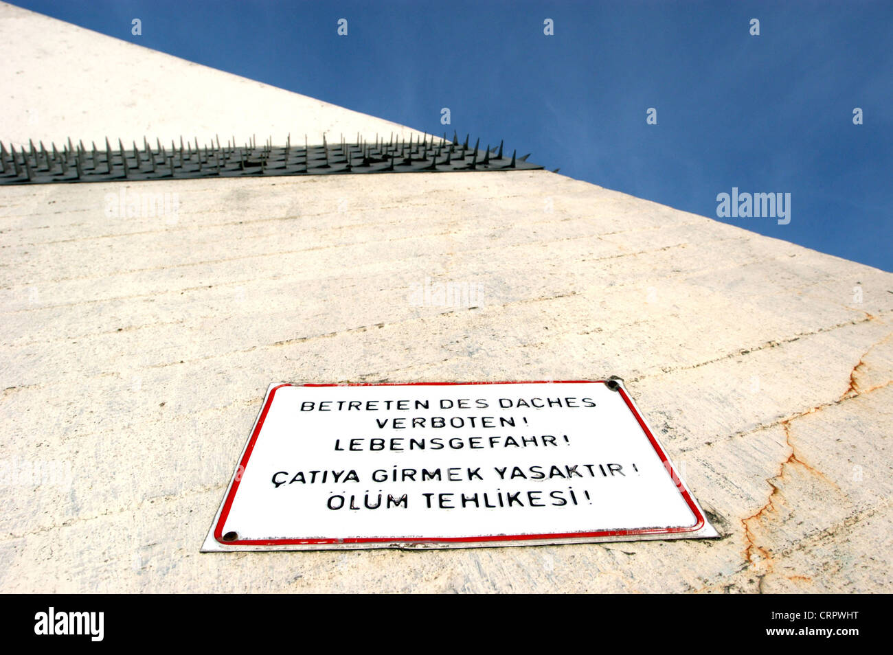 Bilingual entering prohibited! Sign on house wall Stock Photo - Alamy
