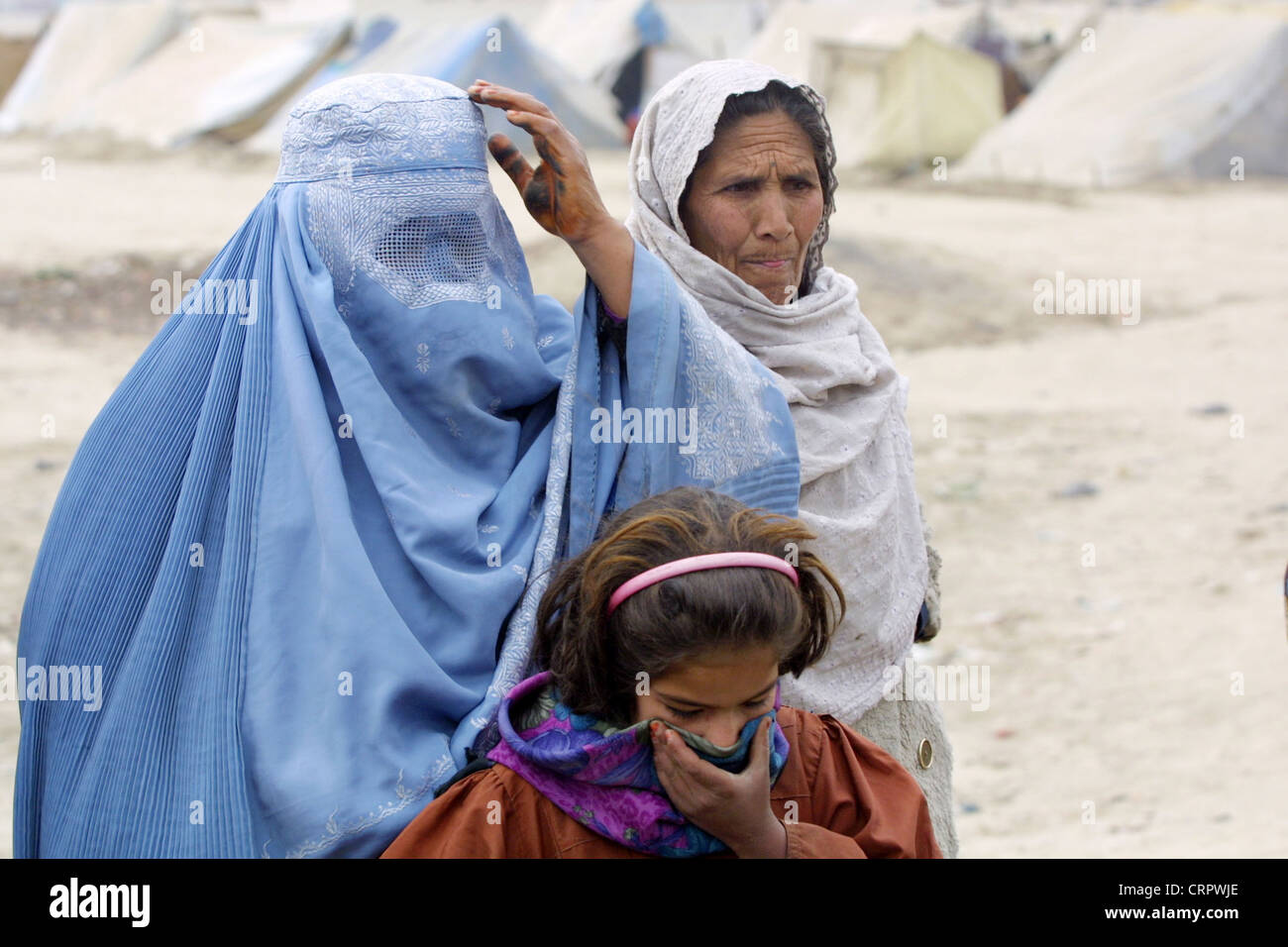 A woman shrouded in a burka with child Stock Photo - Alamy