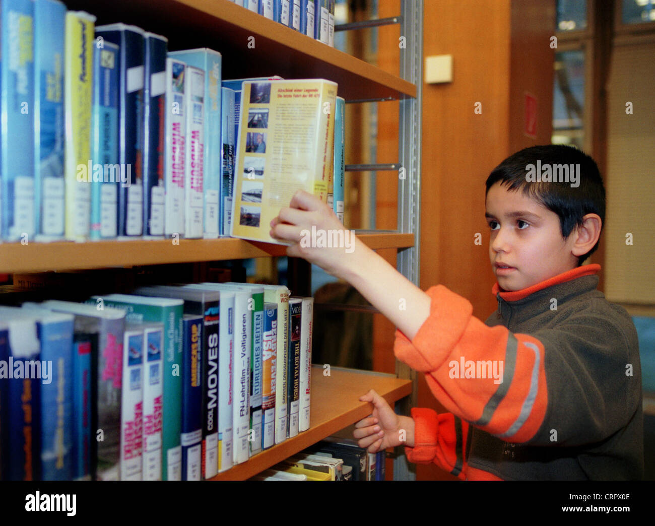 Boy in a library Stock Photo - Alamy