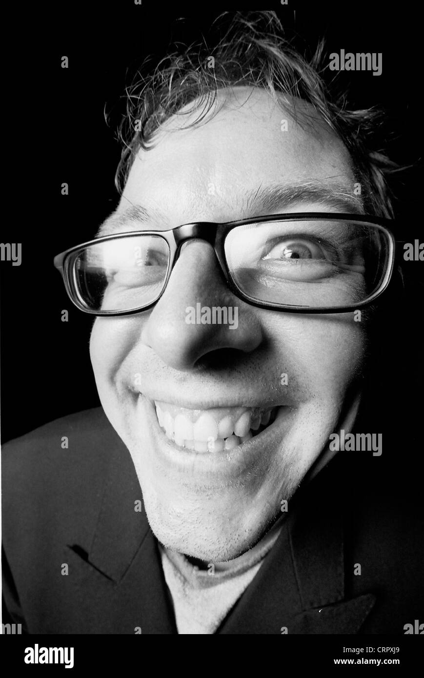Bespectacled man grimaces Stock Photo - Alamy