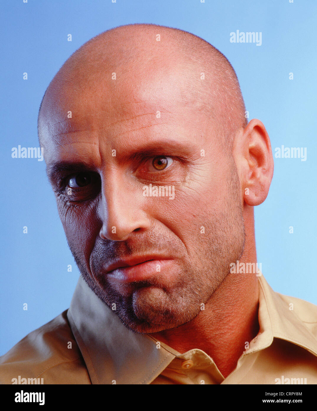 Bald man with angry look Stock Photo - Alamy