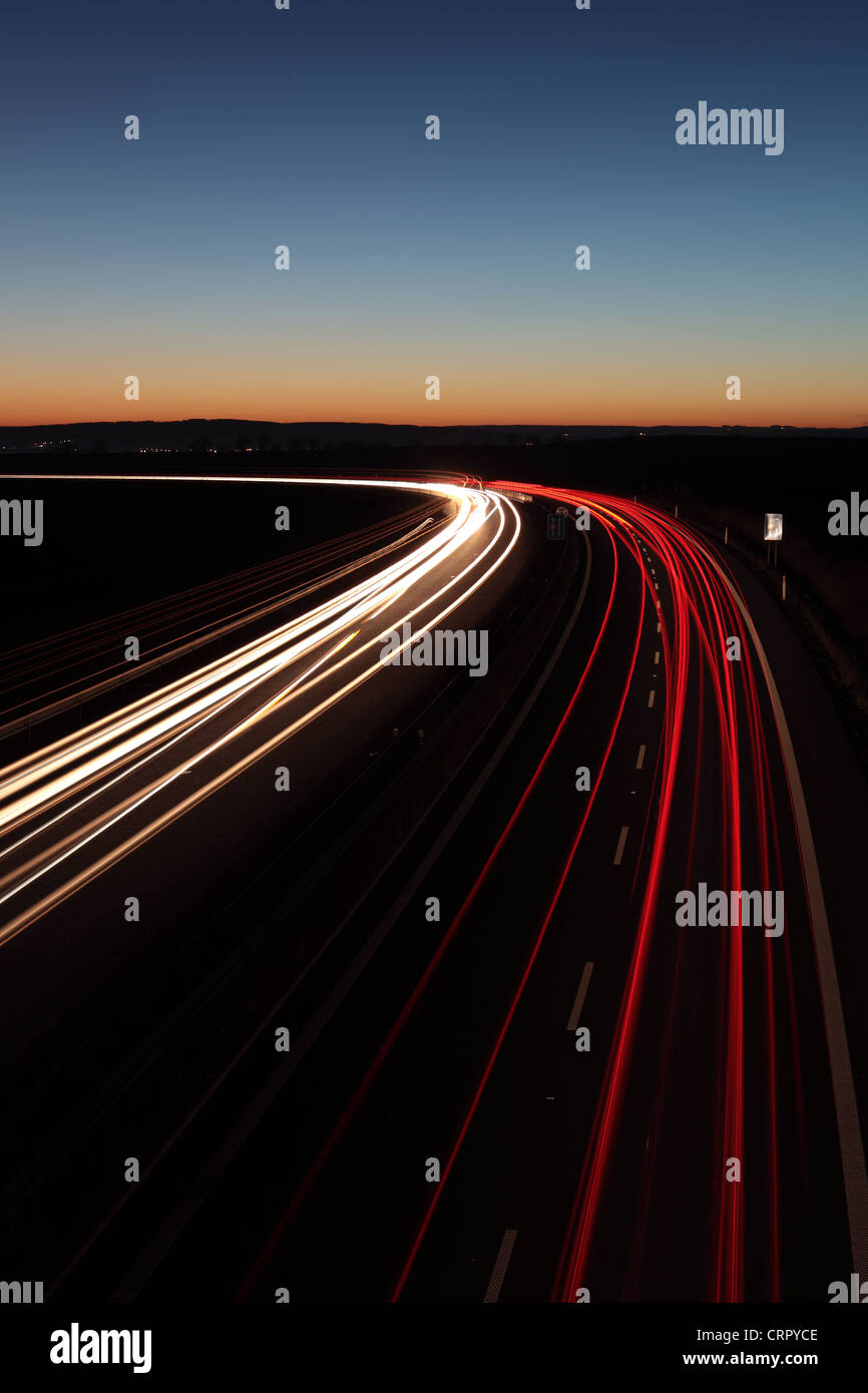 Cars moving fast on a night highway (motion blurred image Stock Photo ...