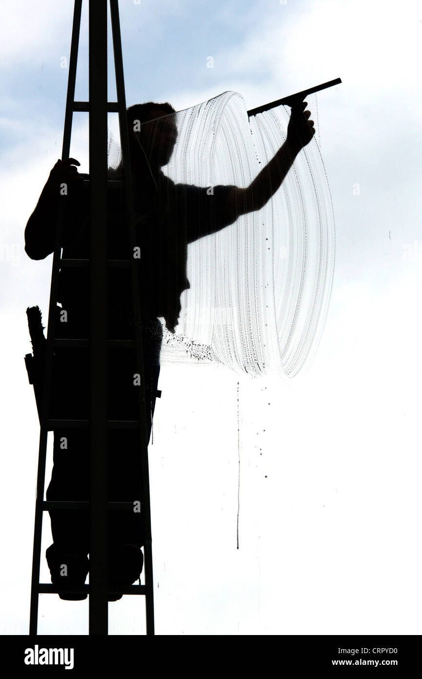 Silhouette of a window cleaner at work Stock Photo - Alamy