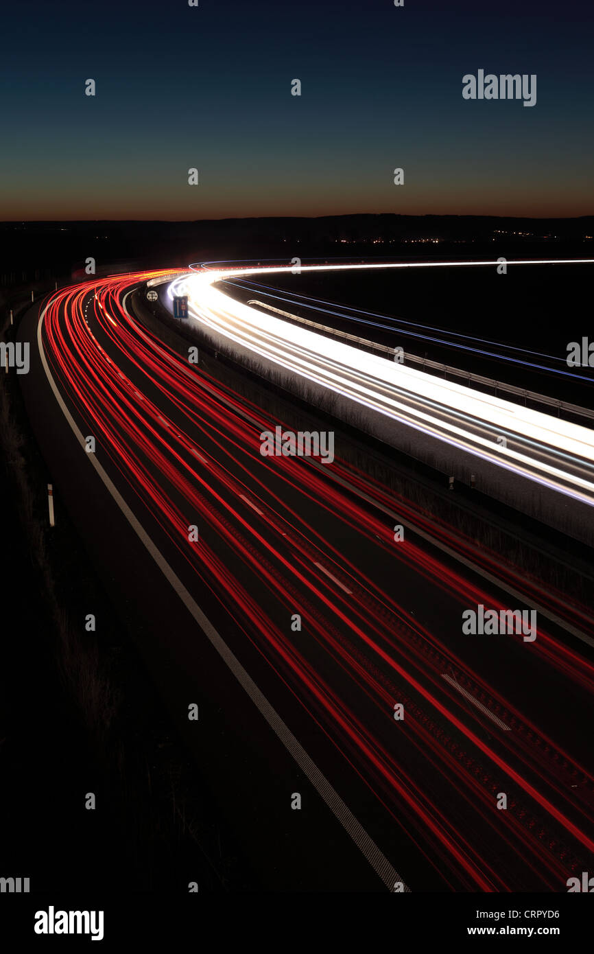 Cars moving fast on a night highway (motion blurred image Stock Photo ...