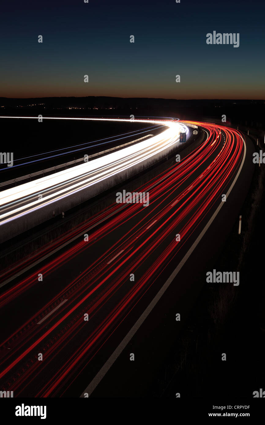 Cars moving fast on a night highway (motion blurred image Stock Photo ...