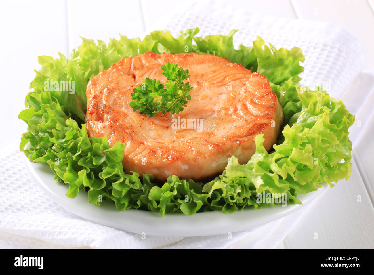 Pan fried salmon patty served on lettuce Stock Photo - Alamy