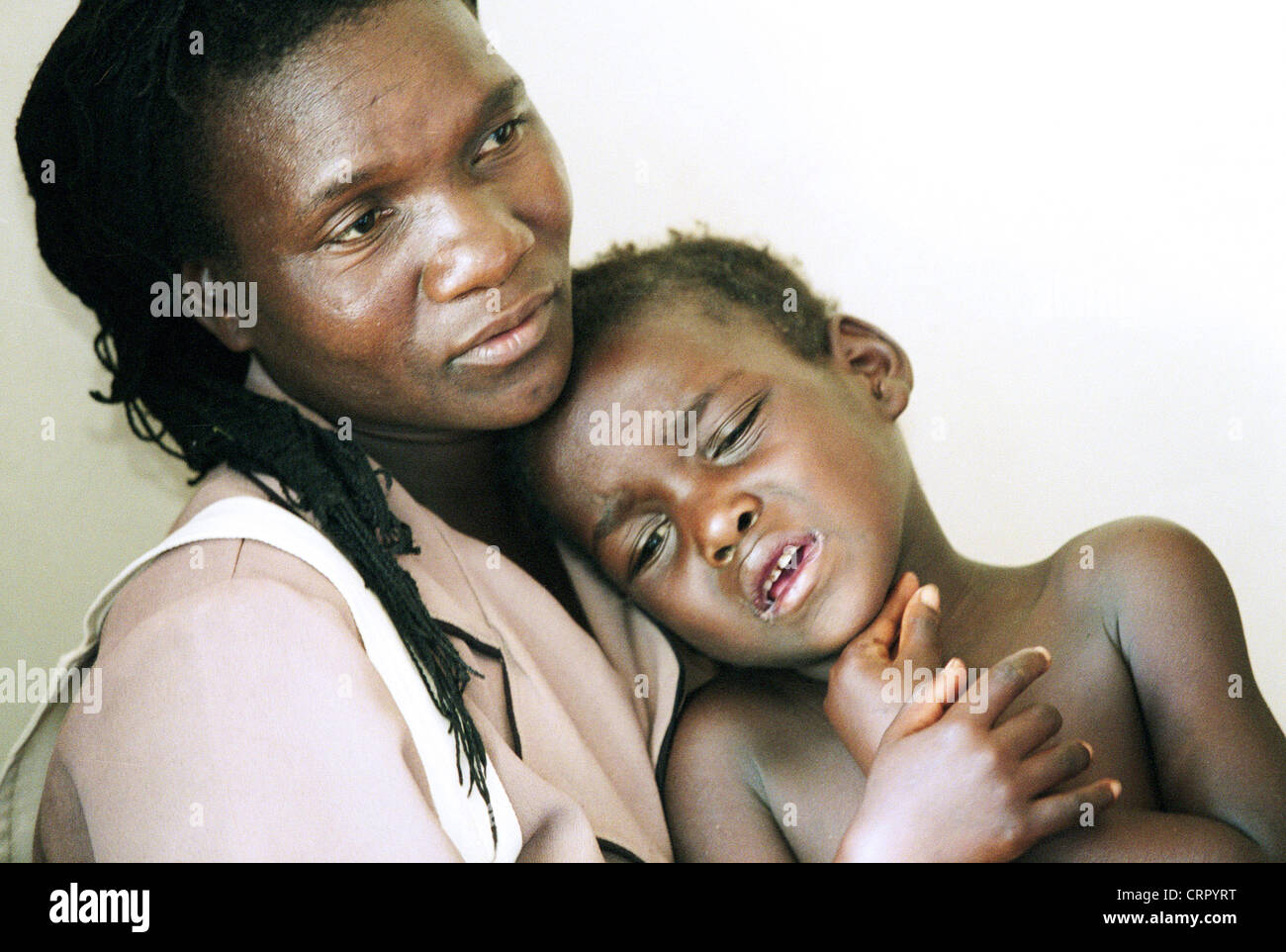 A mother holds her sick child in her arms Stock Photo - Alamy