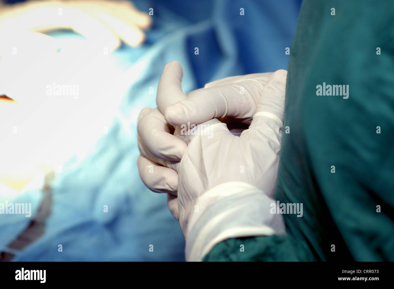 Clasped gloved hands Stock Photo - Alamy