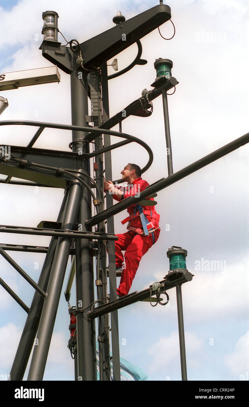 Sailor climbs the signal mast of a ship Stock Photo - Alamy