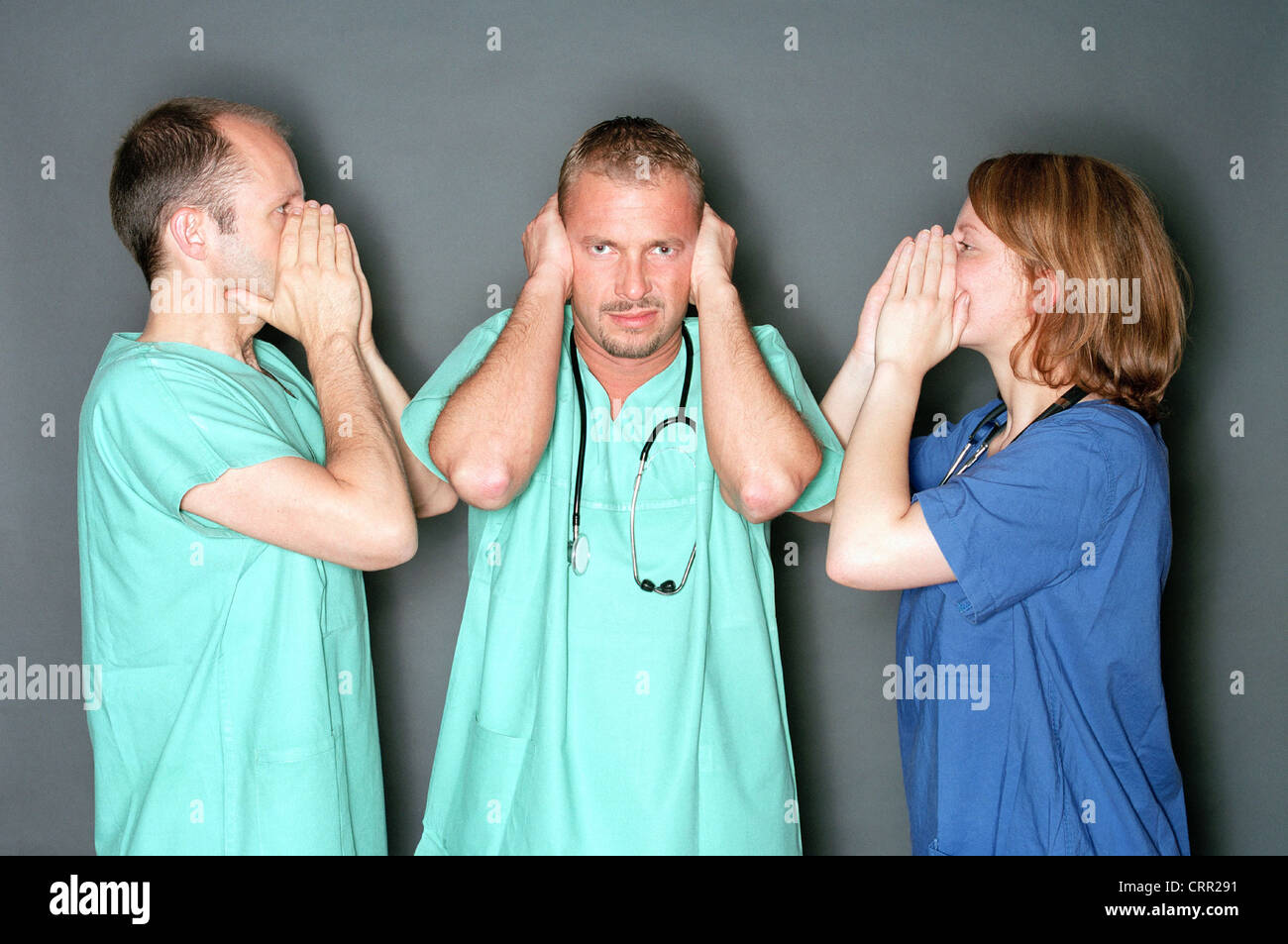 Two doctors screaming at a colleague together Stock Photo - Alamy