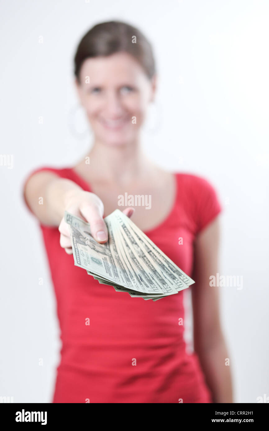 Young woman handing/giving you money Stock Photo - Alamy