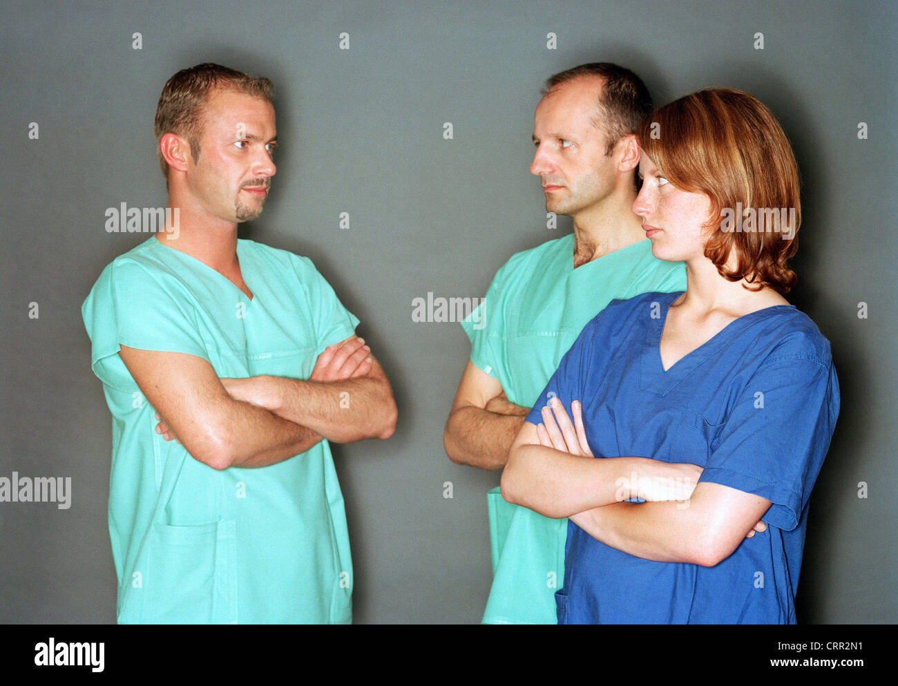 Group of three doctors with folded arms Stock Photo - Alamy