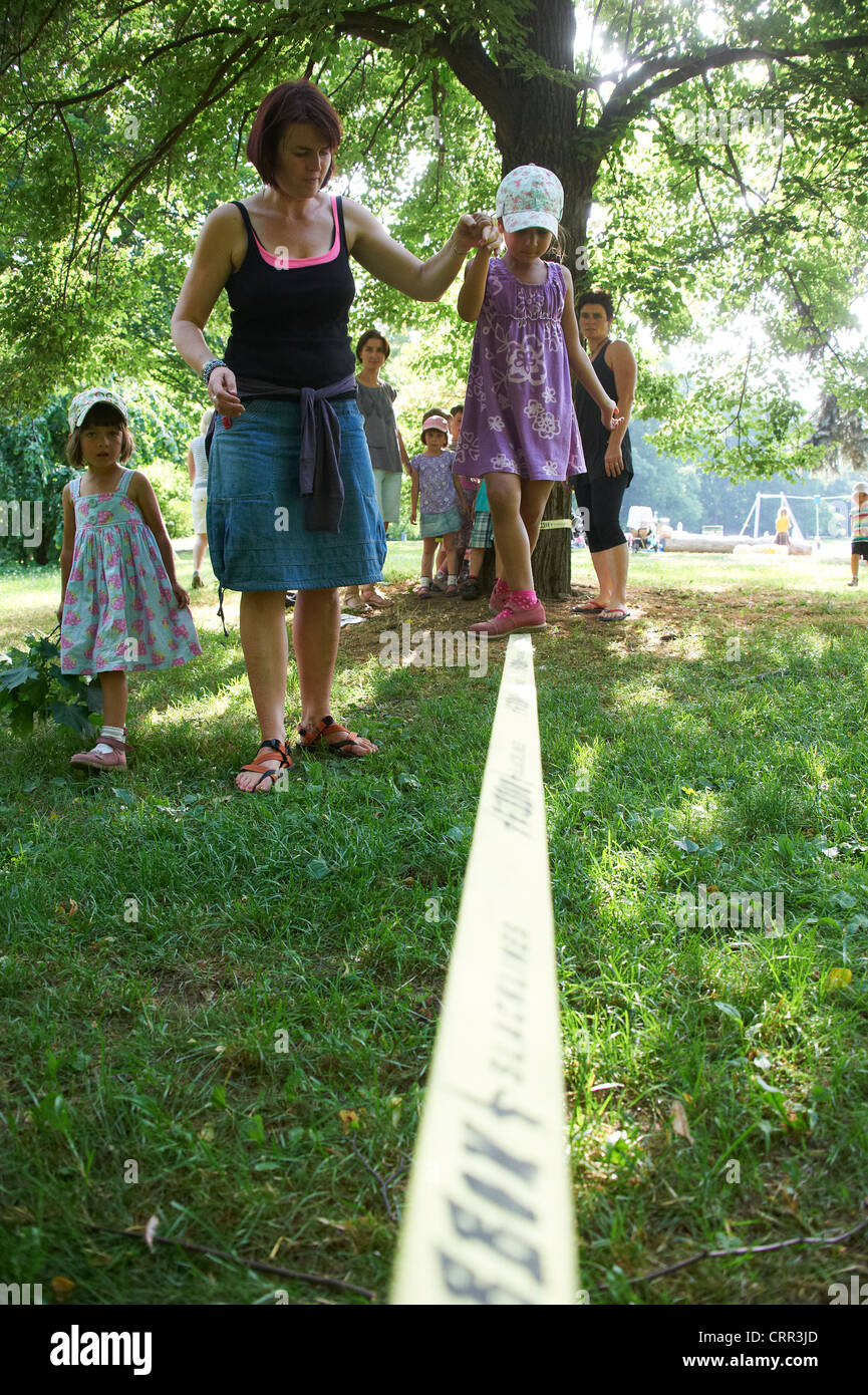 Children and Parents Slacklining in summer park Stock Photo - Alamy