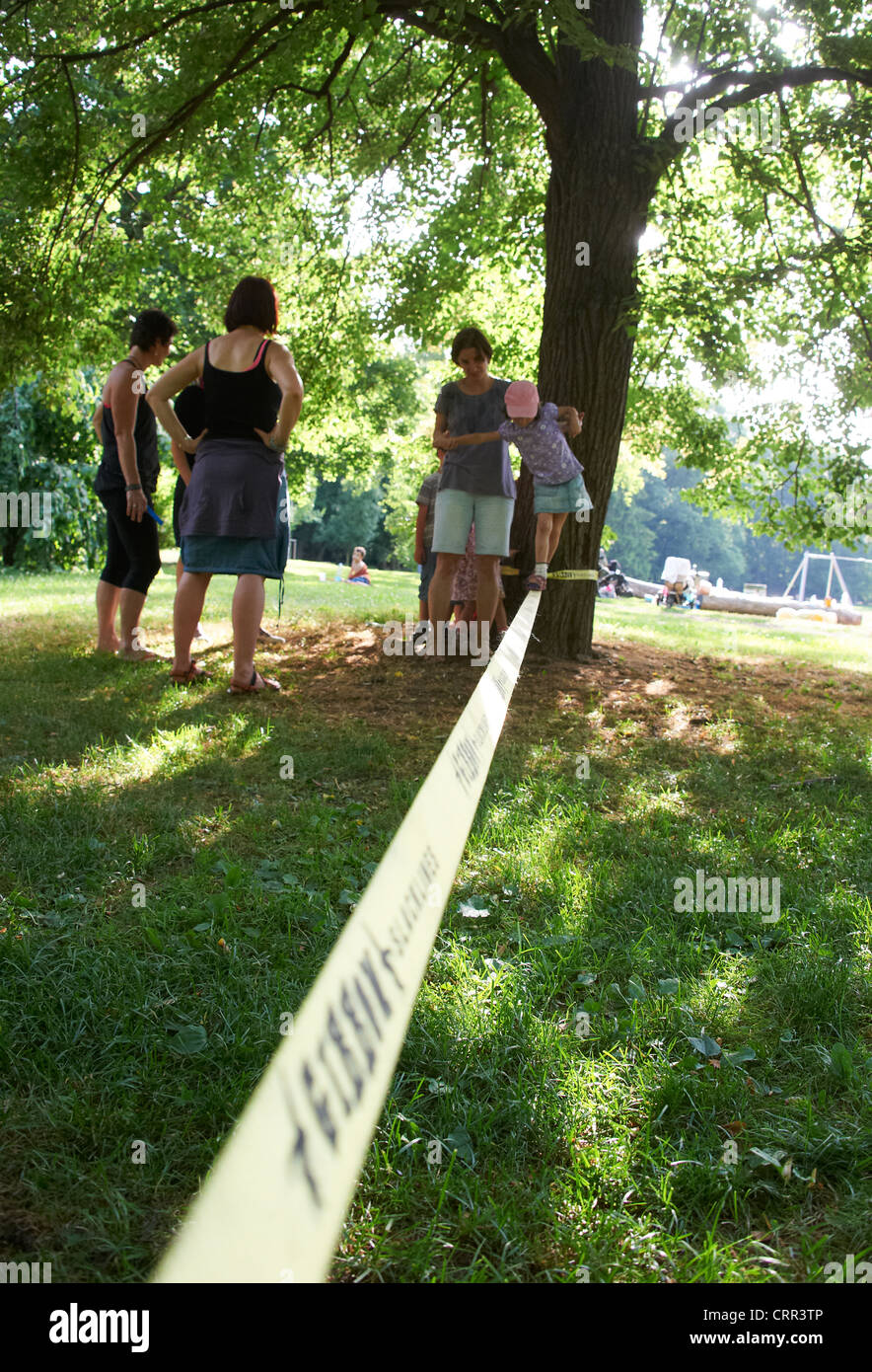 Children and Parents Slacklining in summer park Stock Photo - Alamy
