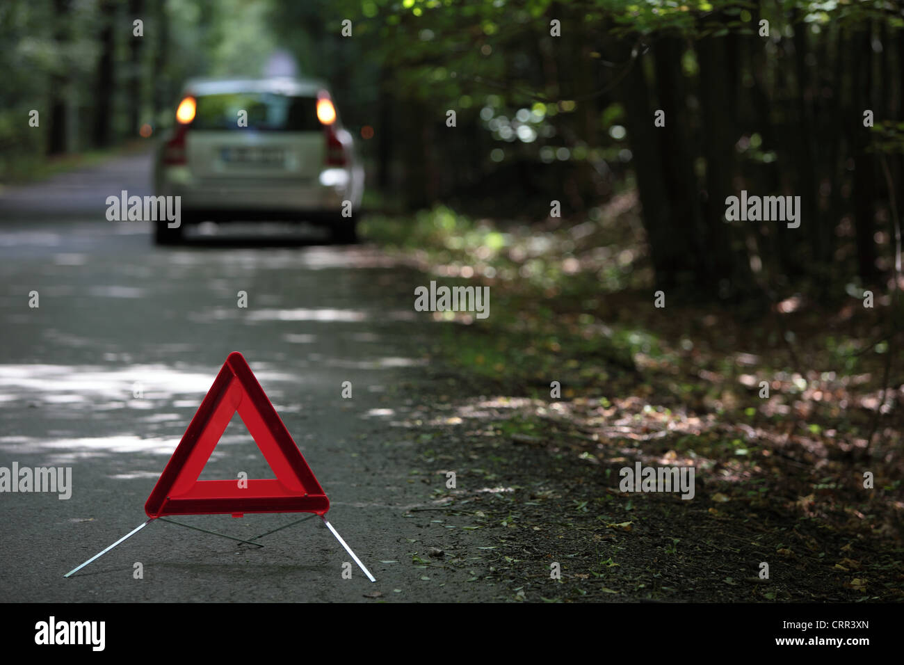 broken down car with warning triangle Stock Photo - Alamy