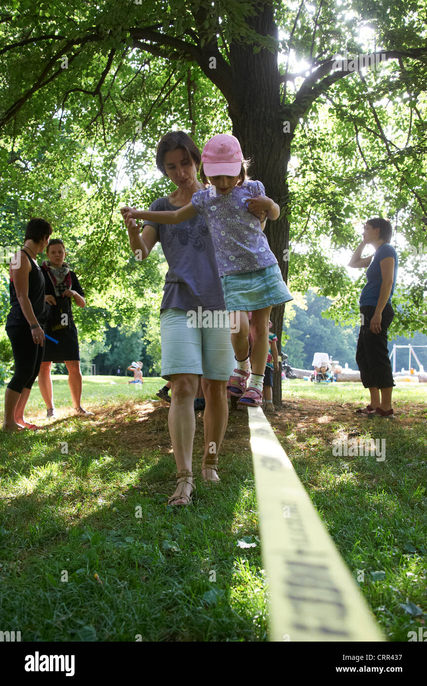 Children and Parents Slacklining in summer park Stock Photo - Alamy
