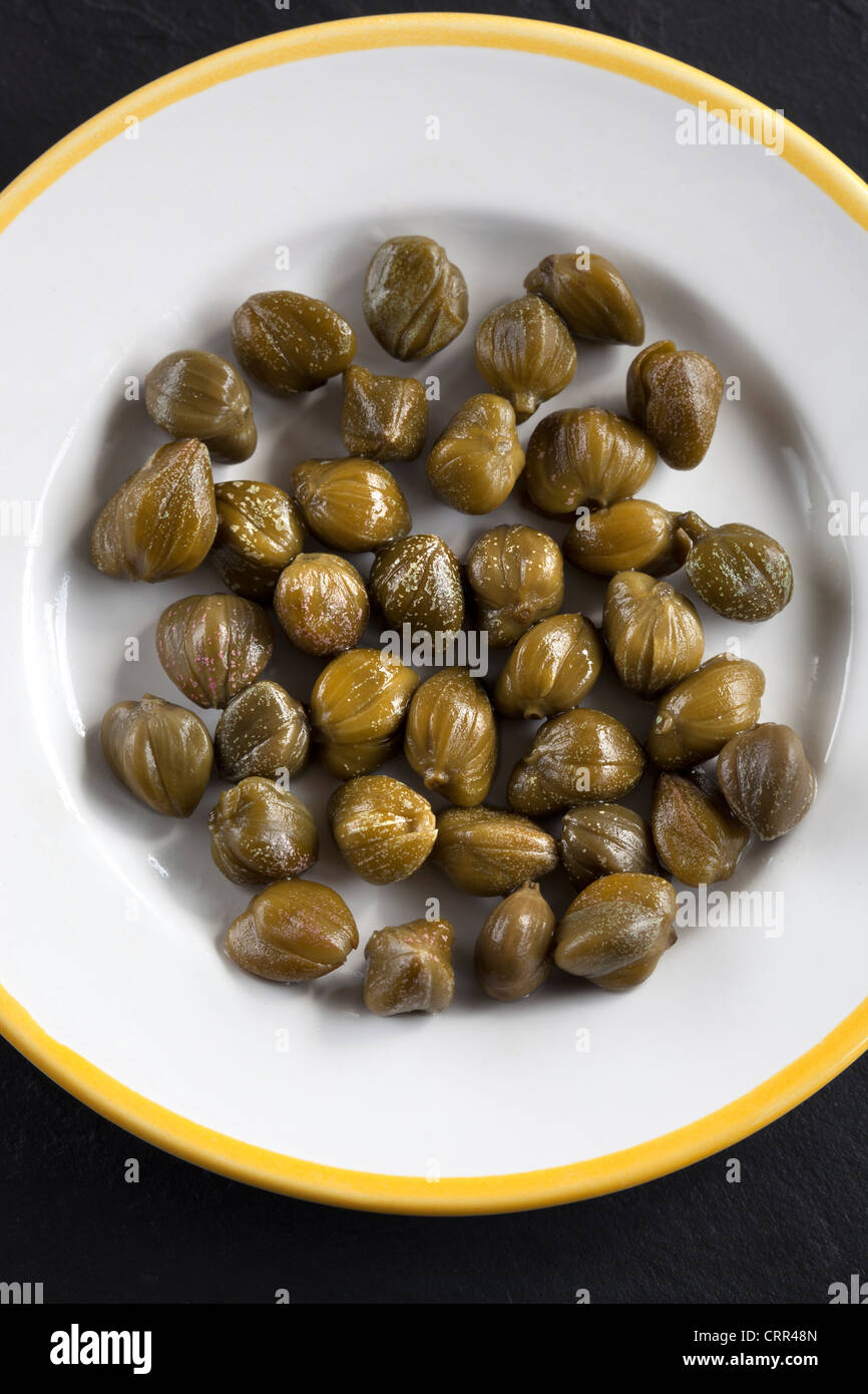 Capers on round plate Stock Photo - Alamy