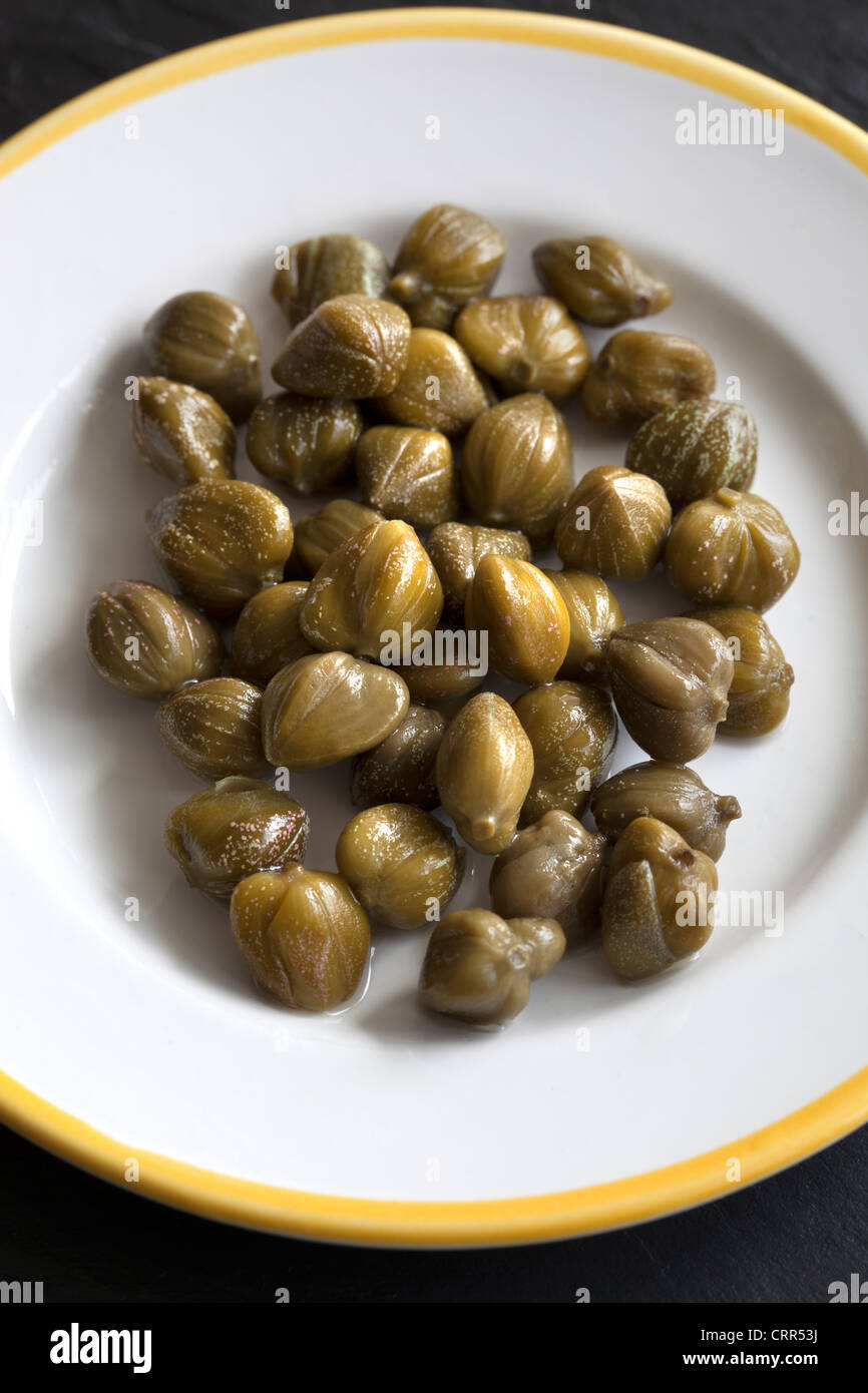 Capers on round plate Stock Photo - Alamy