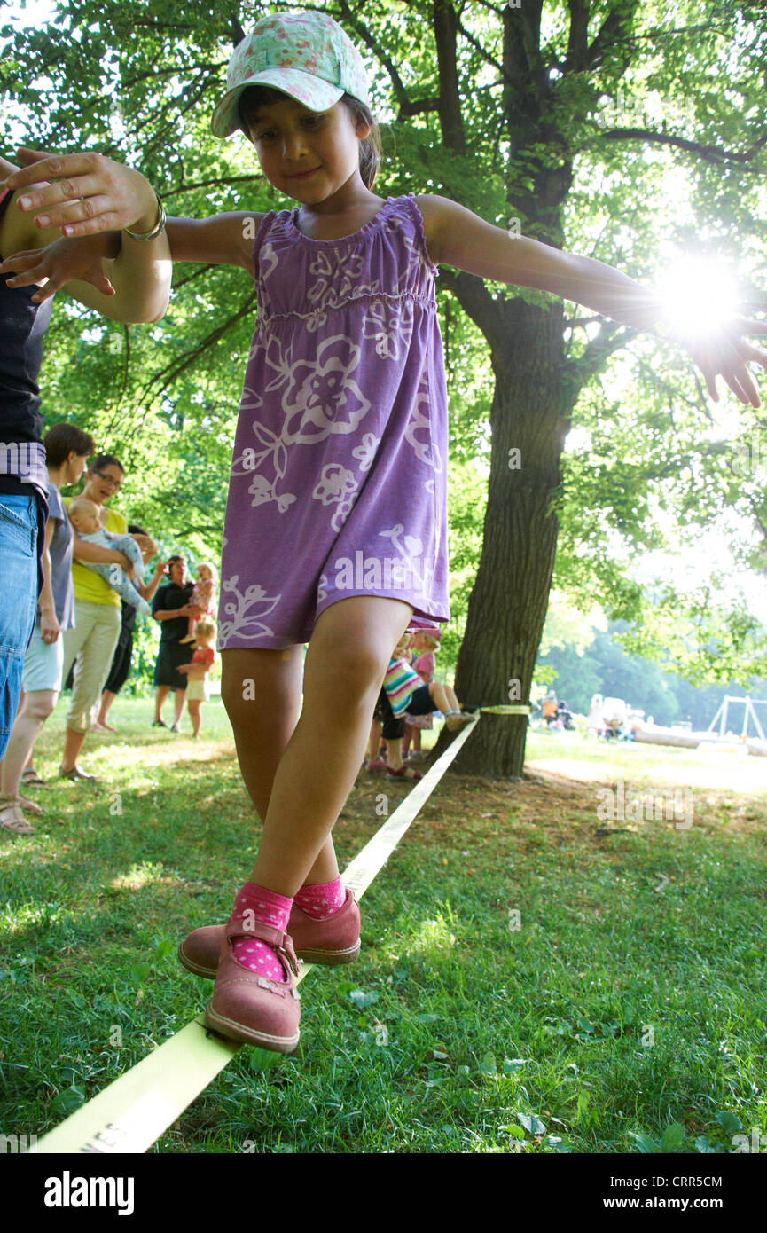 Children and Parents Slacklining in summer park Stock Photo - Alamy