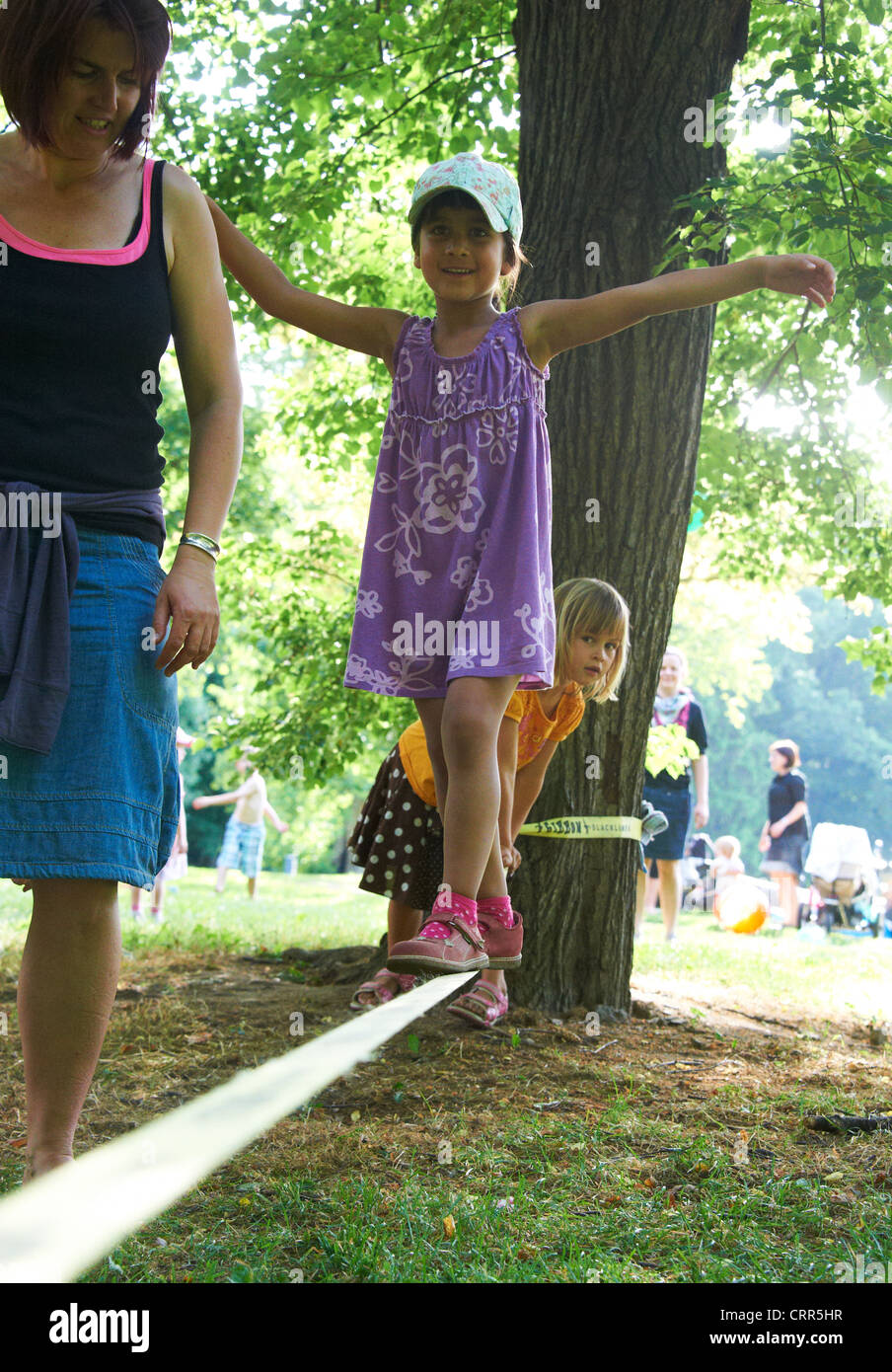 Children and Parents Slacklining in summer park Stock Photo - Alamy