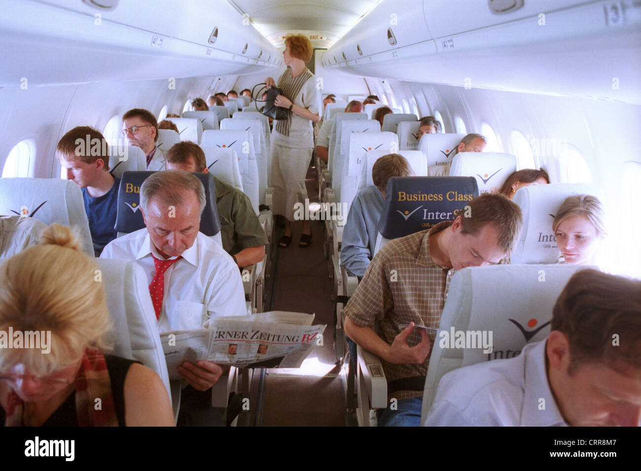 Passengers on the plane Stock Photo - Alamy