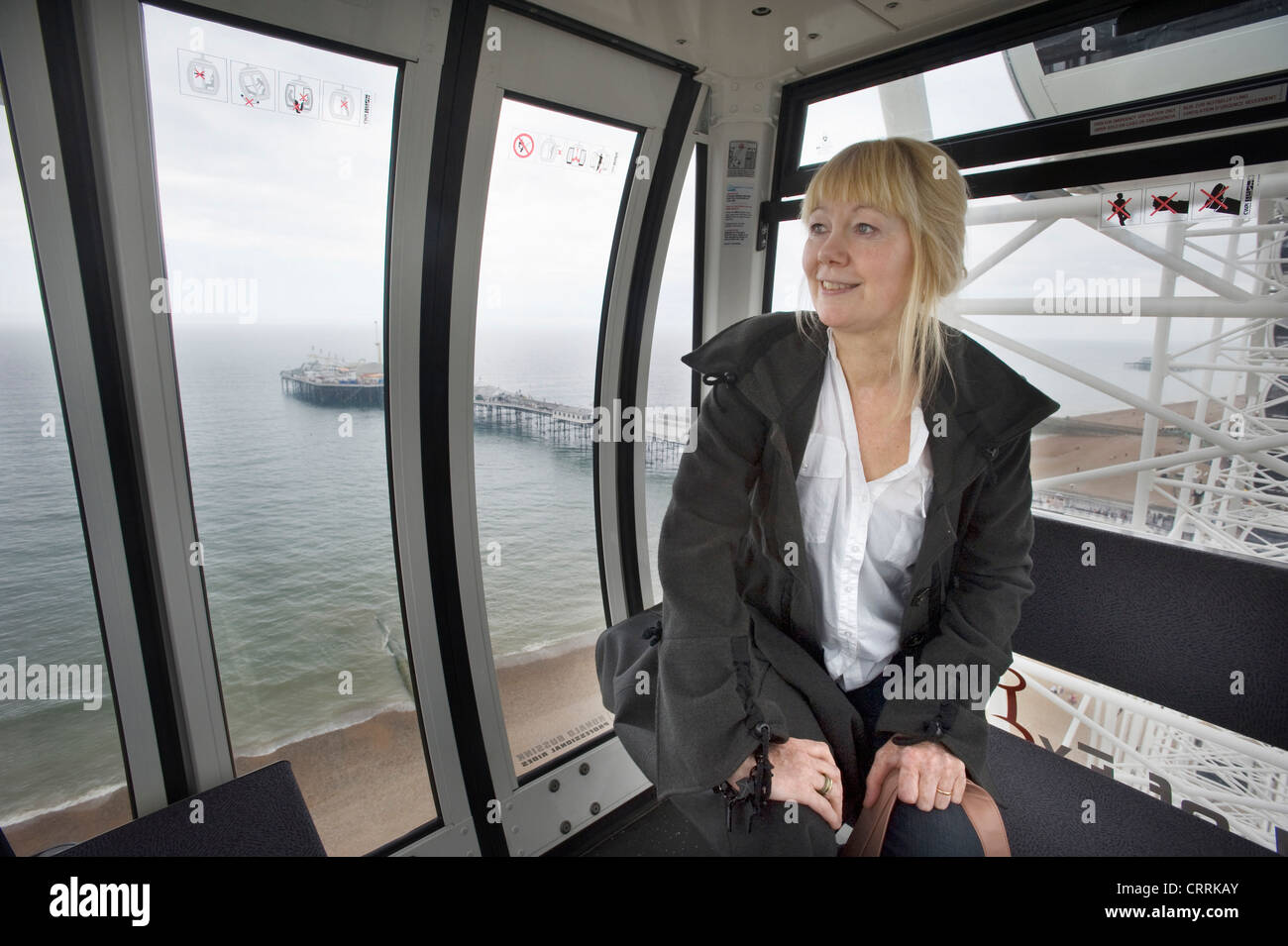 The Brighton Eye Ferris Wheel on Brighton seafront. A woman sightseer ...