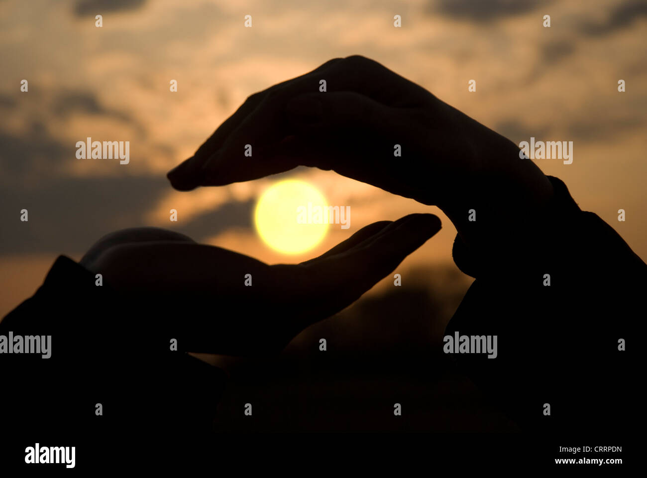 two hands holding the sun Stock Photo - Alamy