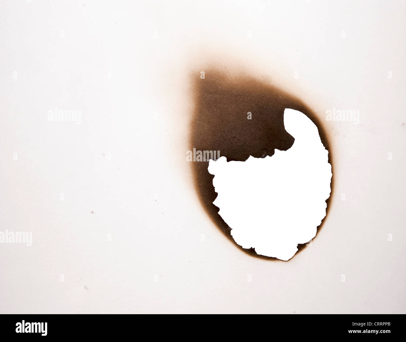 burnt hole in a paper Stock Photo - Alamy