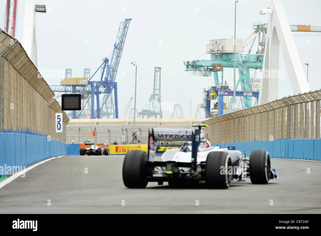 race car on the bridge racing towards port cranes during free practice ...