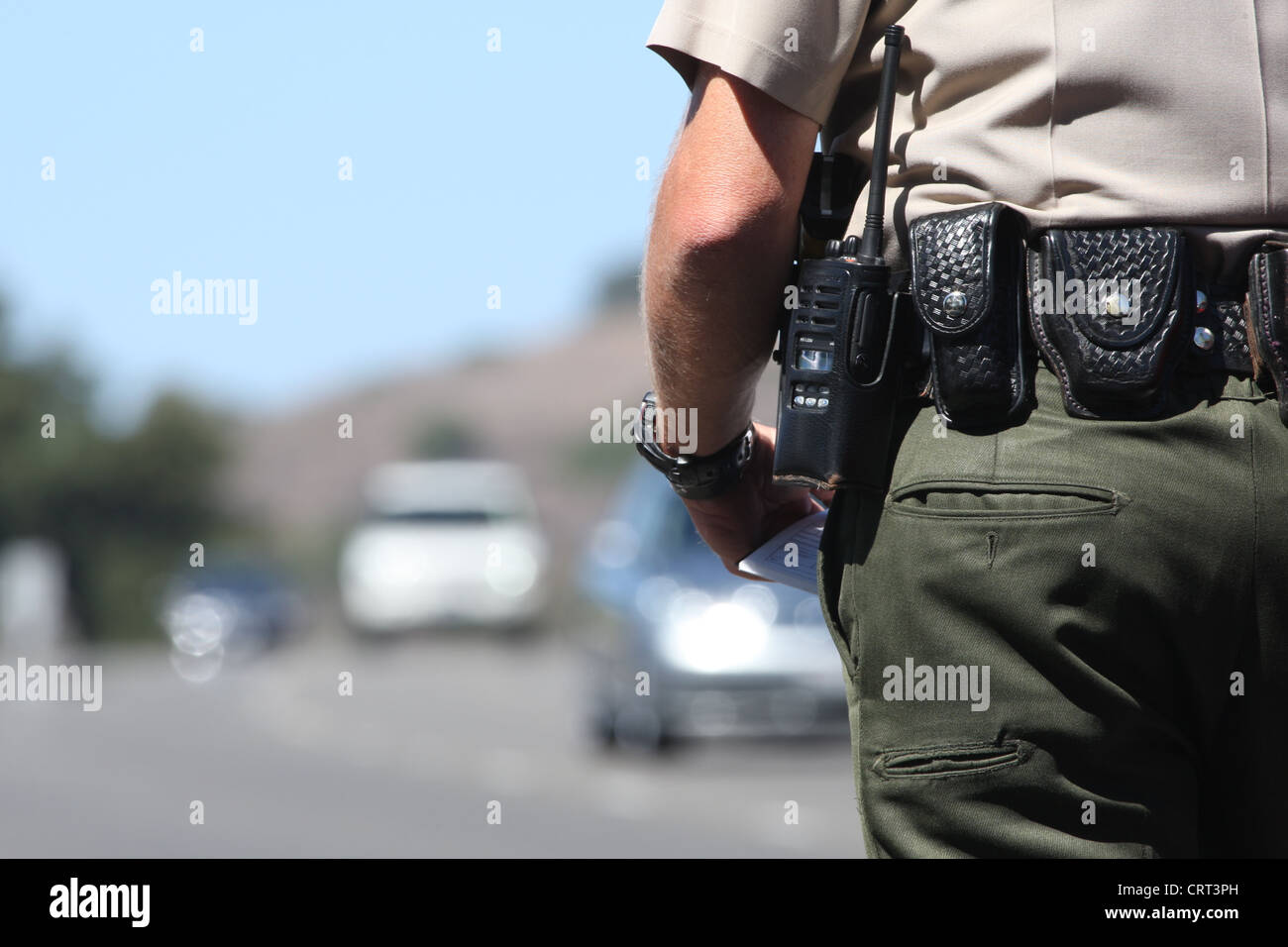 A police officer watching traffic Stock Photo - Alamy
