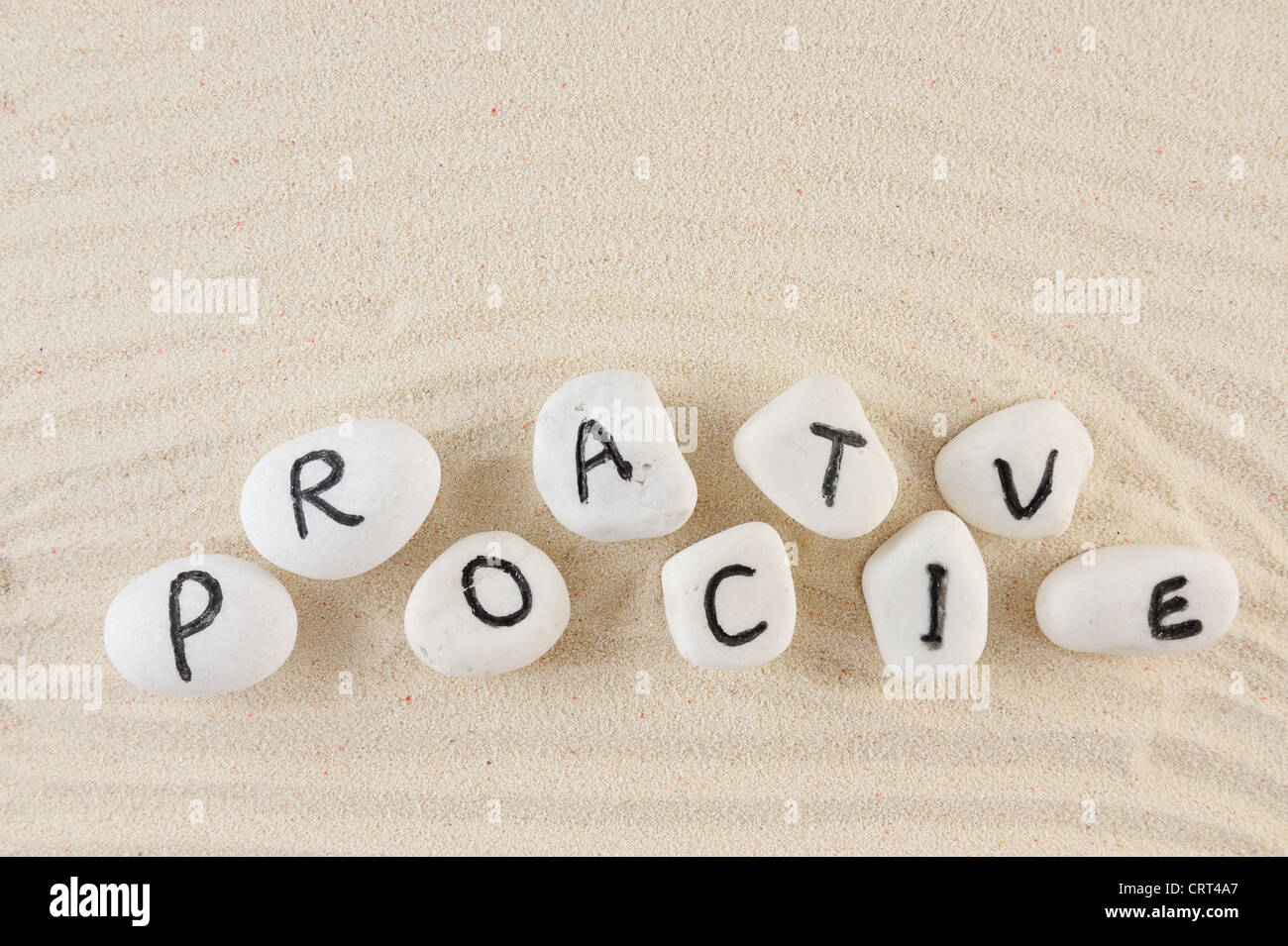 Proactive word on group of stones on the sand Stock Photo - Alamy