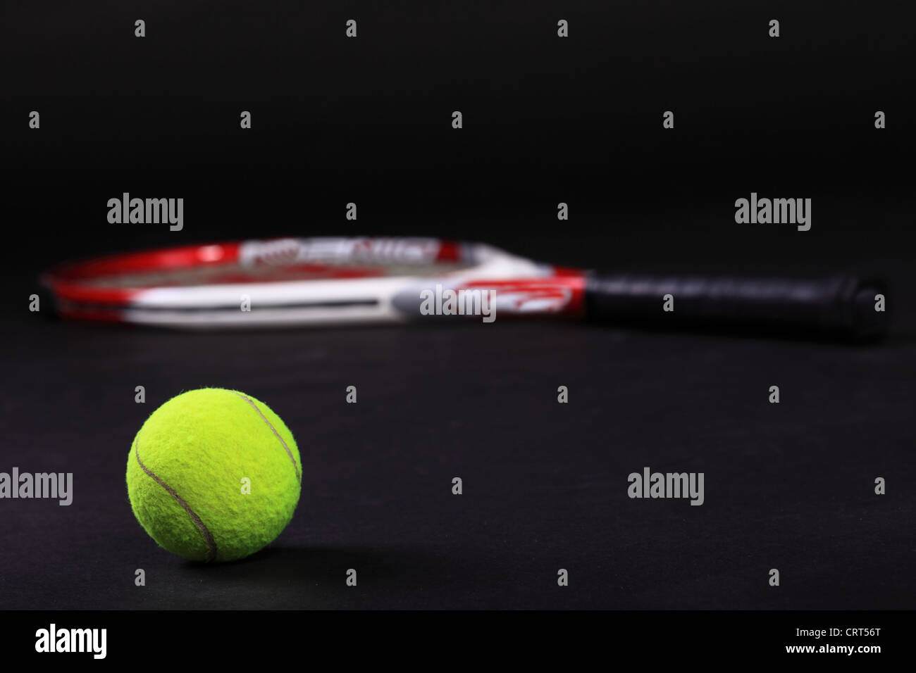 tennis racket and ball on black background studio shot Stock Photo - Alamy