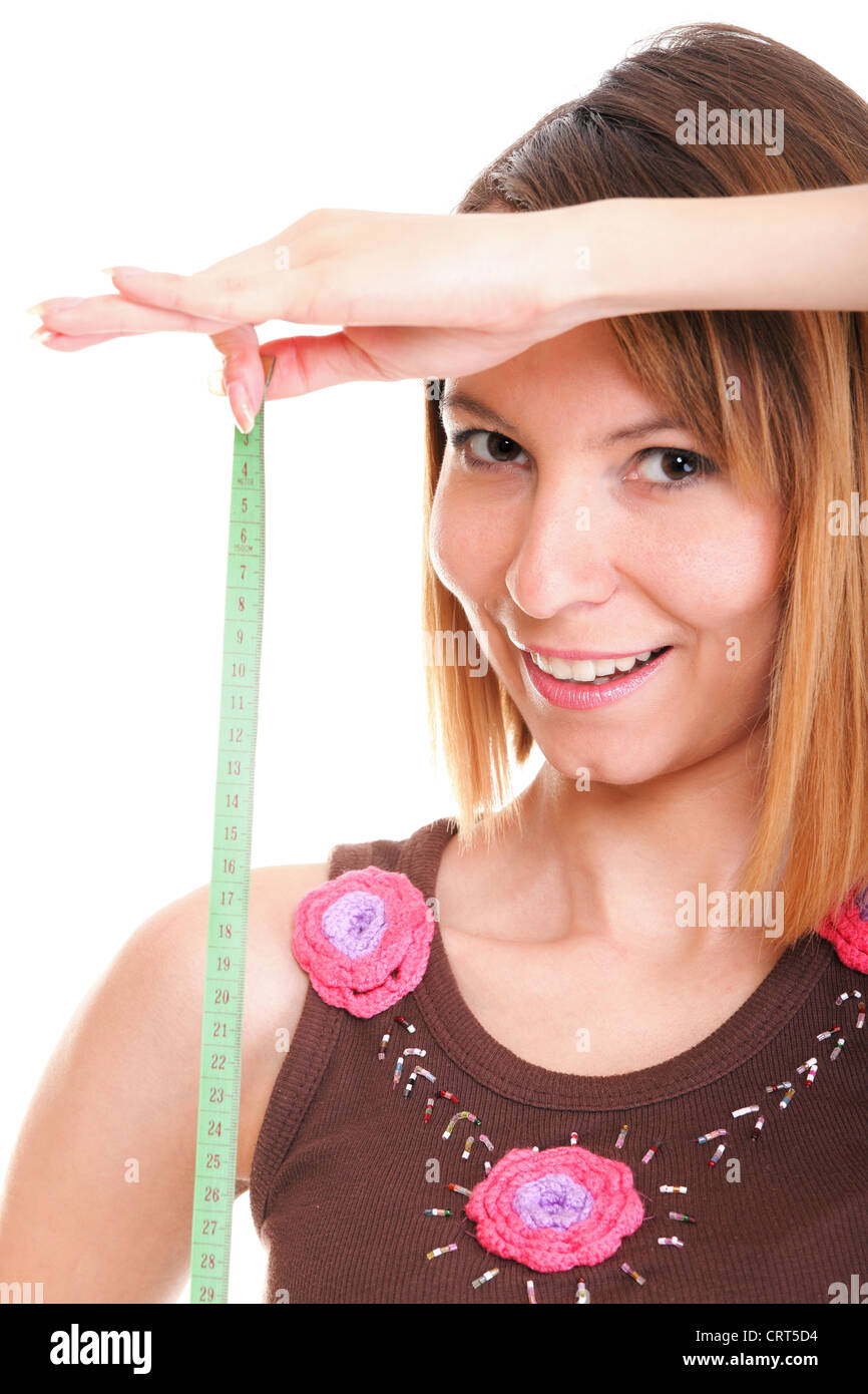 Beautiful young caucasian woman measuring her body with tape, isolated ...