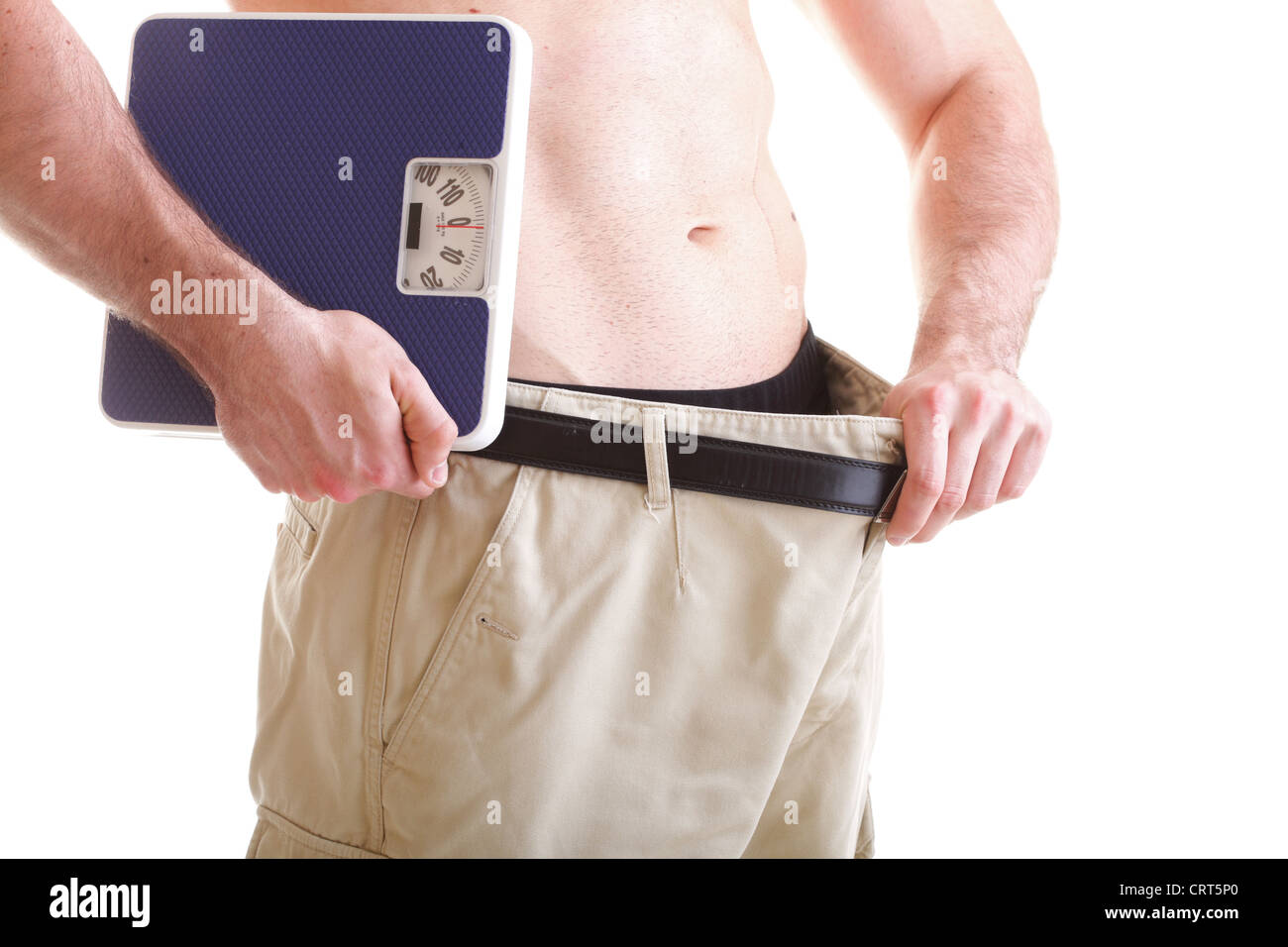Healthy young man with a weight scale. Isolated over white background ...