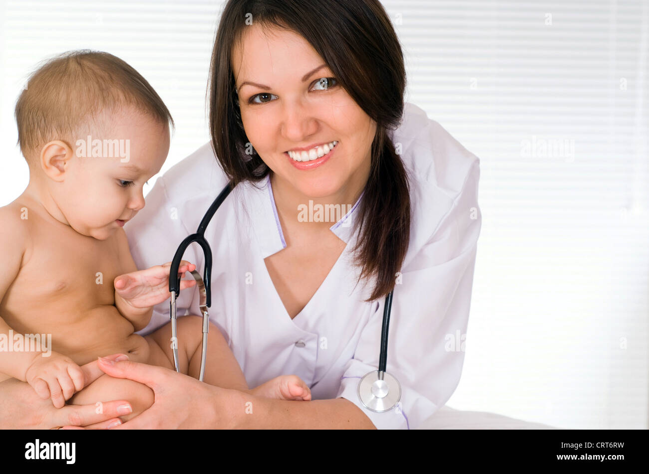 beautiful doctor with newborn on a white background Stock Photo - Alamy