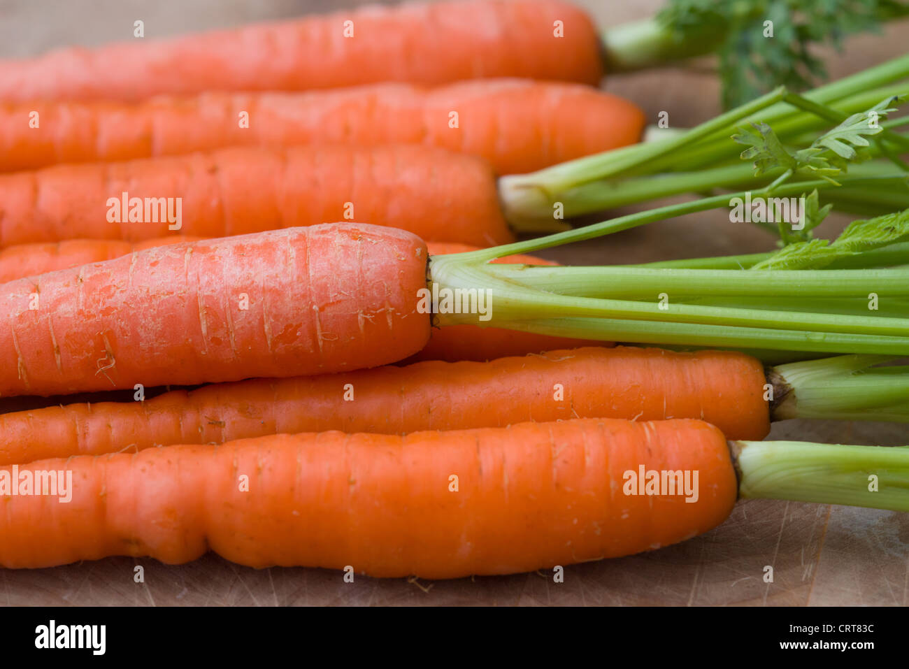 Carrots on a chopping block Stock Photo - Alamy