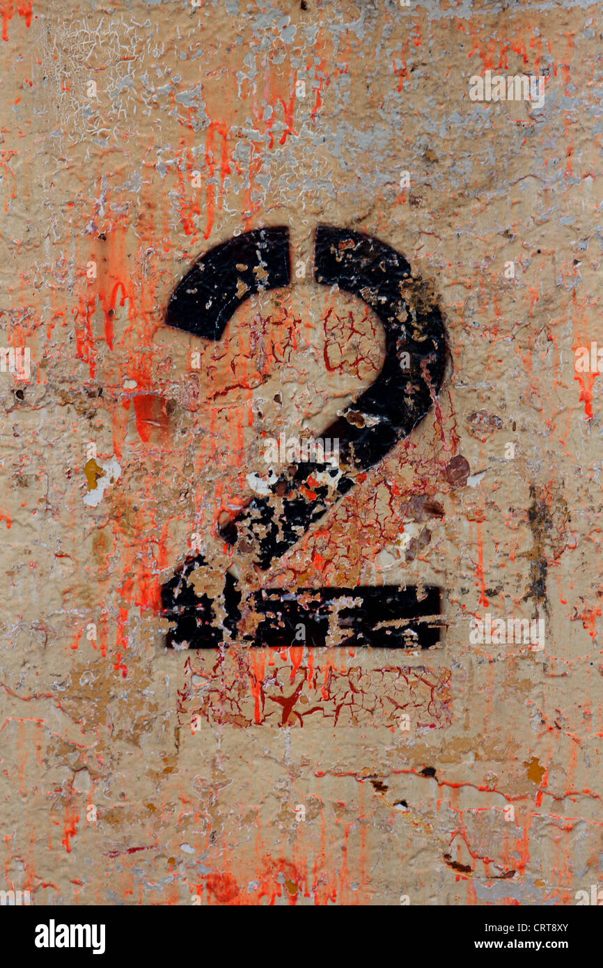 The number 2 (two) painted in black on a multi-colored background at an ...